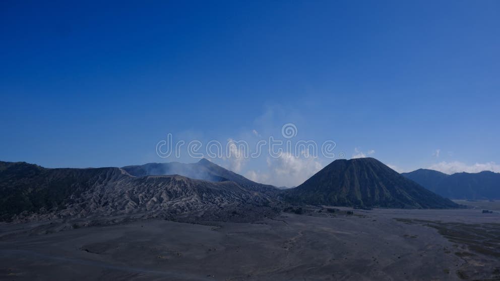 A Mountain Range with a Volcano in the Middle Stock Image - Image of ...