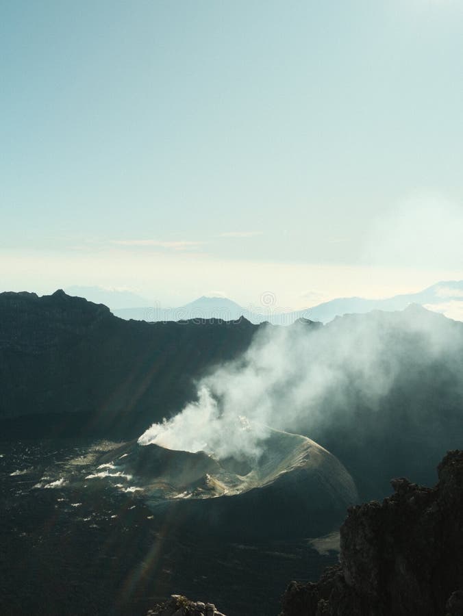 A Mountain Range with a Volcano in the Middle Stock Photo - Image of ...