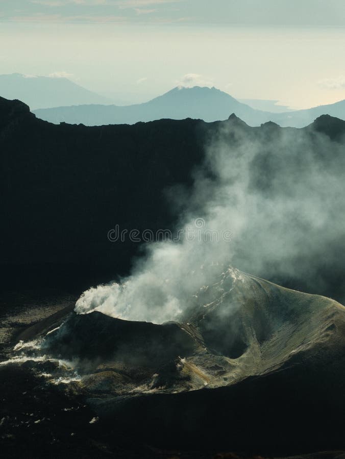 A Mountain Range with a Volcano in the Middle Stock Photo - Image of ...