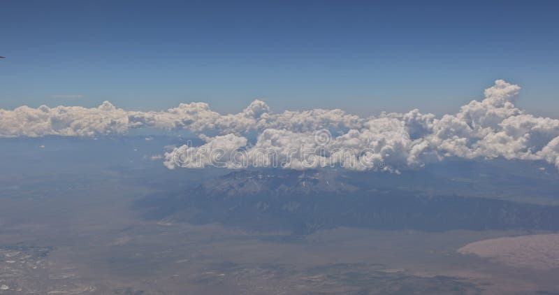 Mountain Ranges and Clouds As Seen through the Window of an Airplane As ...