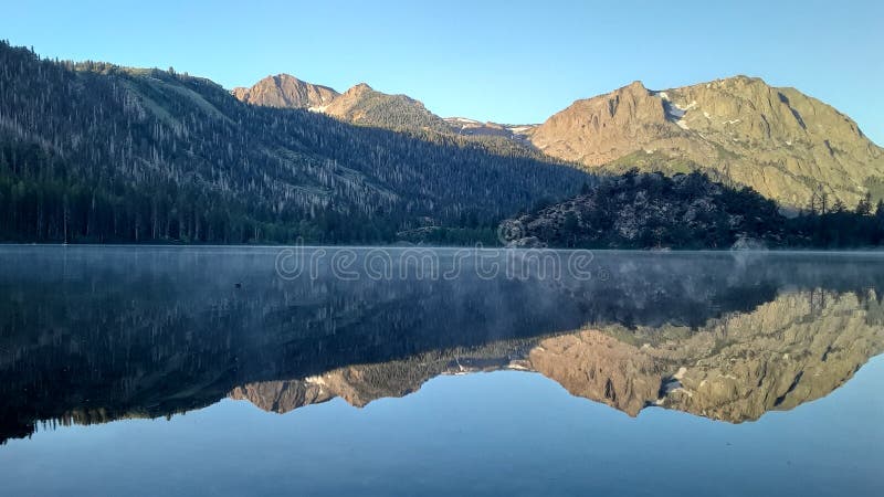 Mountain Reflection at Dawn on a Still Lake Stock Photo - Image of dawn ...