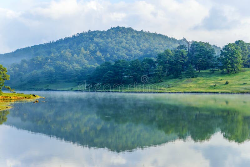 The Mountain Reflection in the Water Stock Image - Image of grass ...