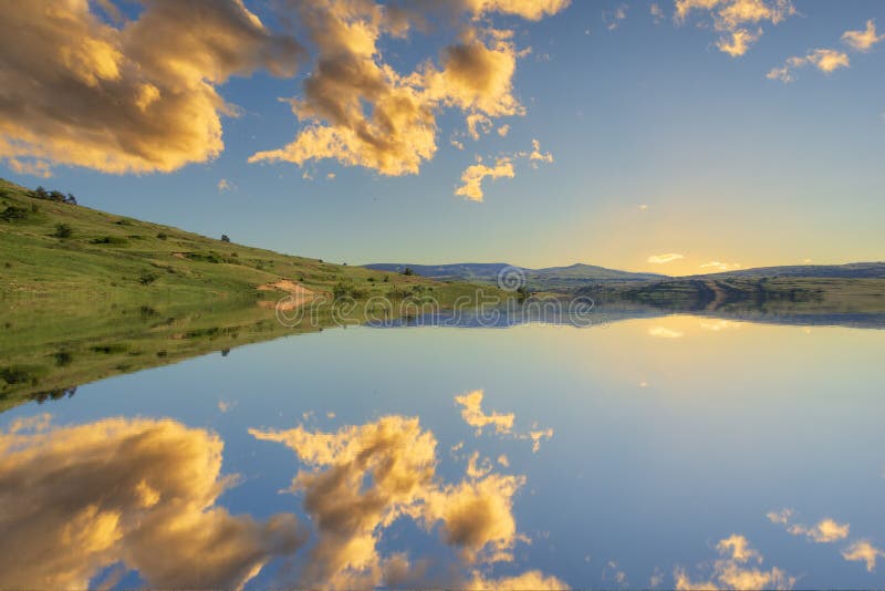 Mountain Reflections and Clouds in the Water Stock Photo - Image of ...