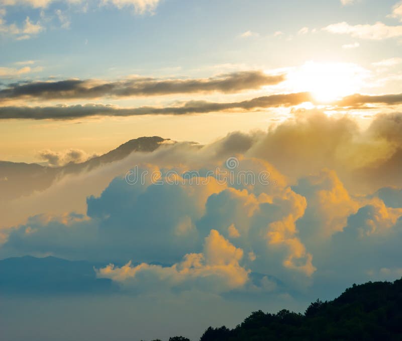 Mountain Ridge Silhouette in Dense Mist and Clouds Stock Photo - Image ...