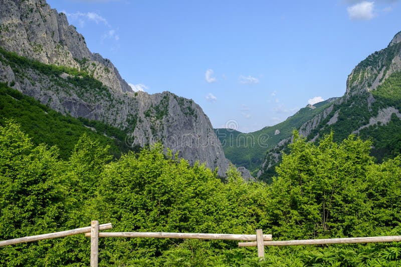 Mountain Ridge Surrounded by Greenery Against a Background of Cloudy ...