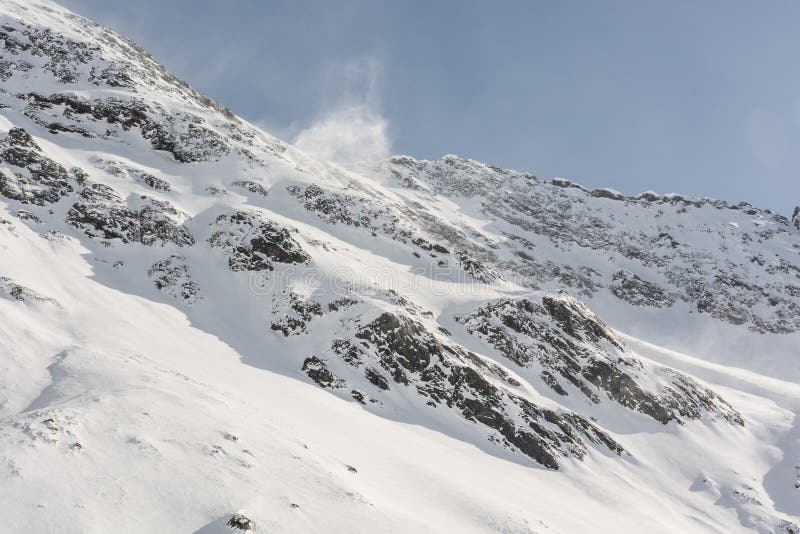 Mountain Ridge with Wind Blowing Off Some Snow Stock Photo - Image of ...