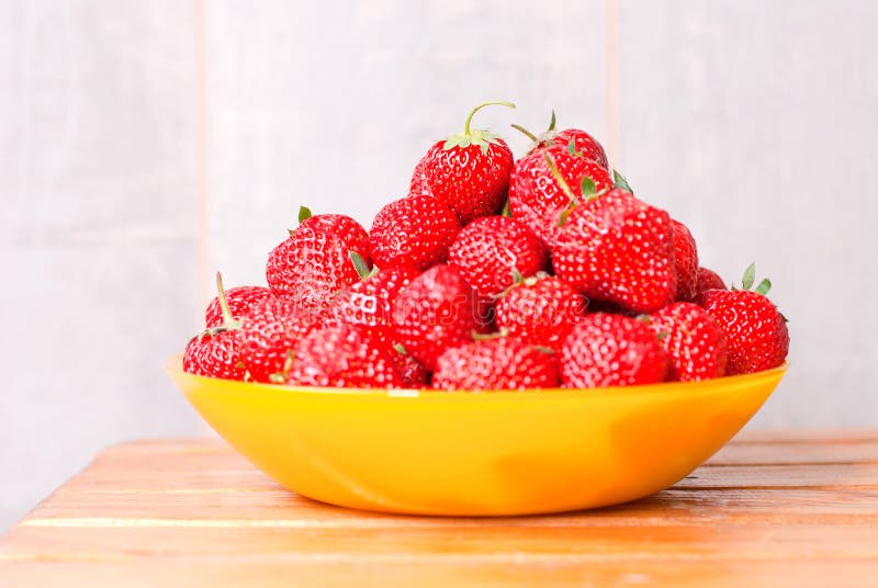 Mountain Ripe Strawberries in the Yellow Bowl on the Table, Side Stock ...