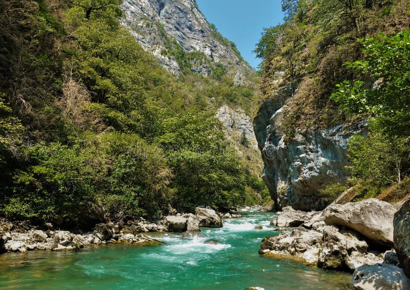 The Mountain River Flows between the Steep Mountain Slopes. the ...