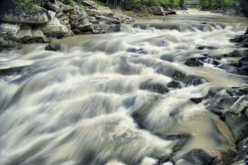 A Mountain River Slowly Flows Over the Stones Like a Small Waterfall ...