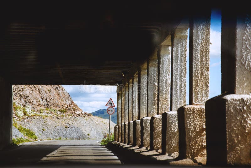 Mountain Road Trip . Inside the Tunnel with Columns. Road Sign. Georgia ...
