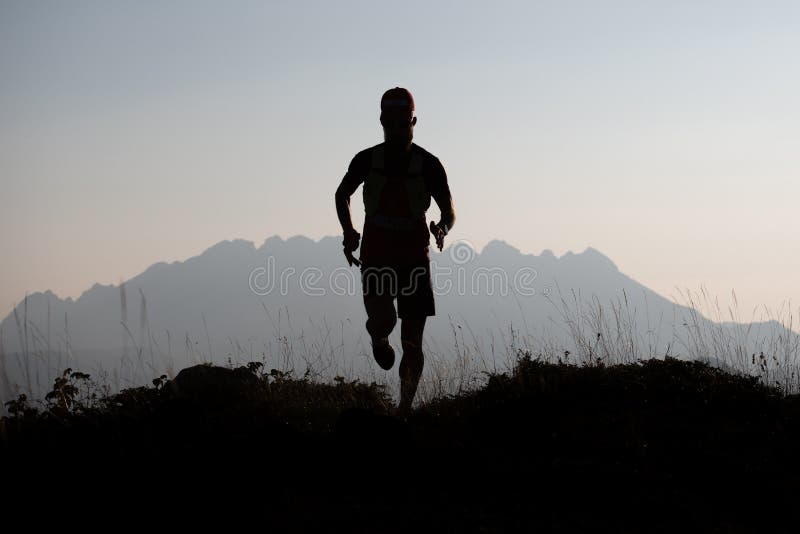 Mountain Runner in Silhouette in a Suggestive Landscape Stock Image ...