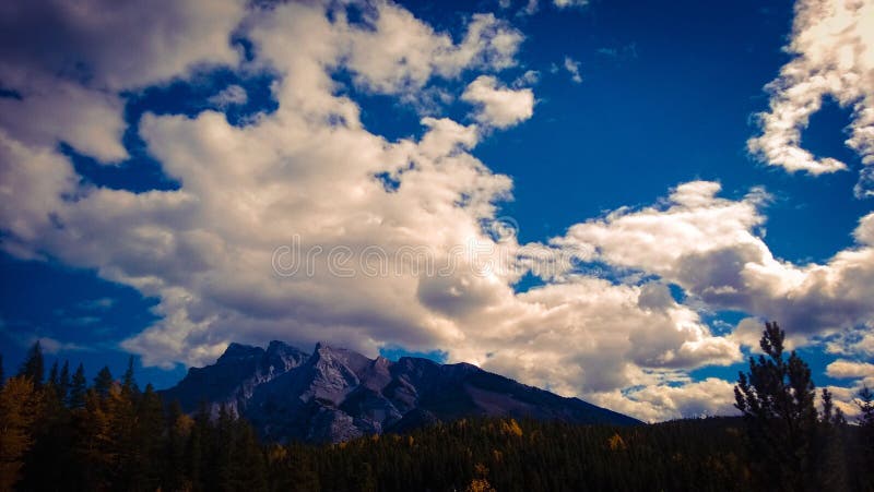 Mountain Storm Rolling Over Sunlight Rundle Stock Photo - Image of golf ...
