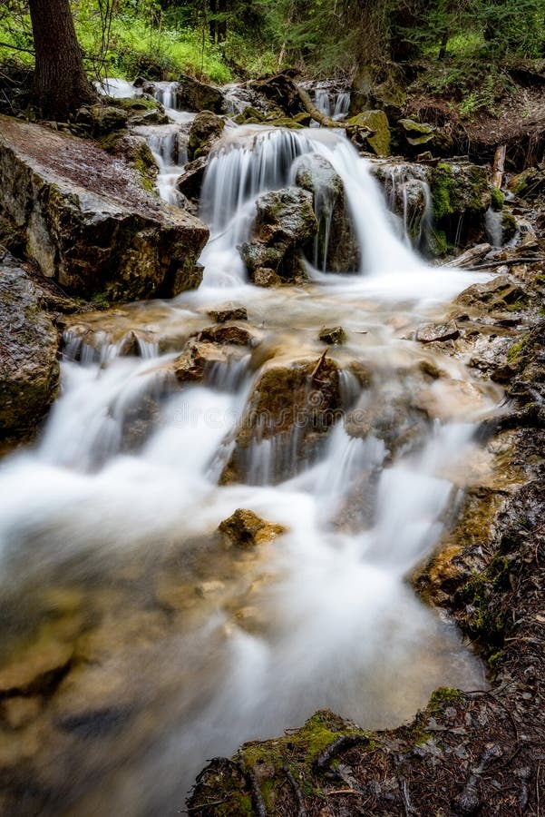 Mountain Stream Cascades Over Rocks Forming a Waterfall Stock Image ...