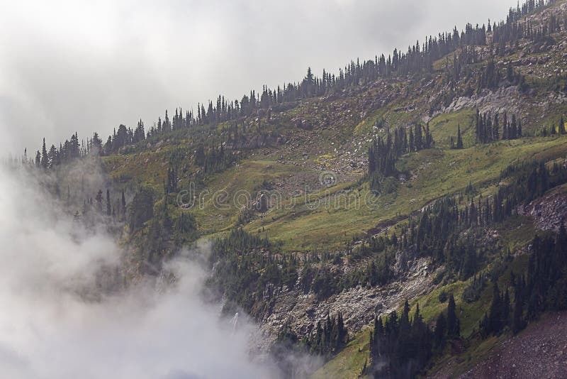 Mountain Top Peaking Out of the Clouds Stock Image - Image of mountain ...