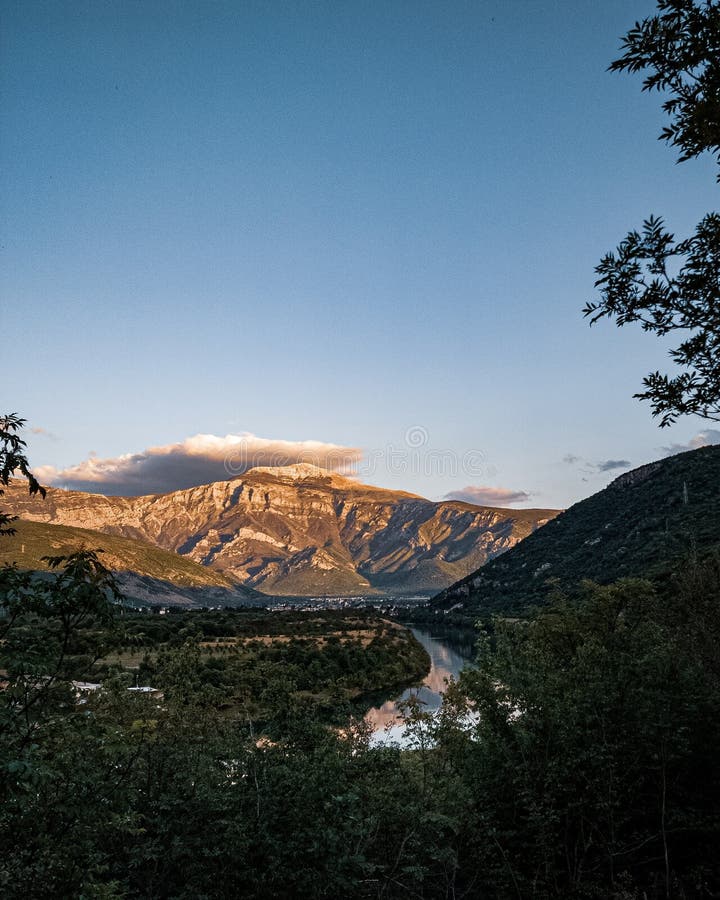 A Mountain Under the Clouds Lit by the Sun Stock Photo - Image of ...