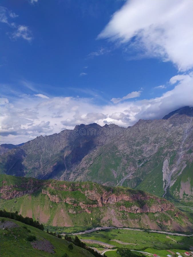 Mountain Valley in Clouds and Green Fields Stock Photo - Image of blue ...