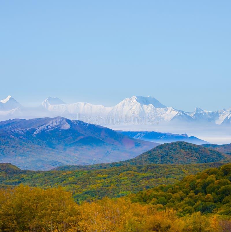 Mountain Valley with Red Forest and Snowbound Mountain Chain Stock ...