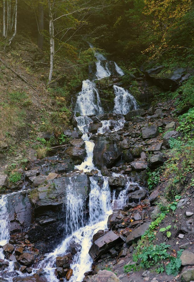 A Mountain Waterfall Flows Over the Rocks. Waterfall Cascade on Mossy ...
