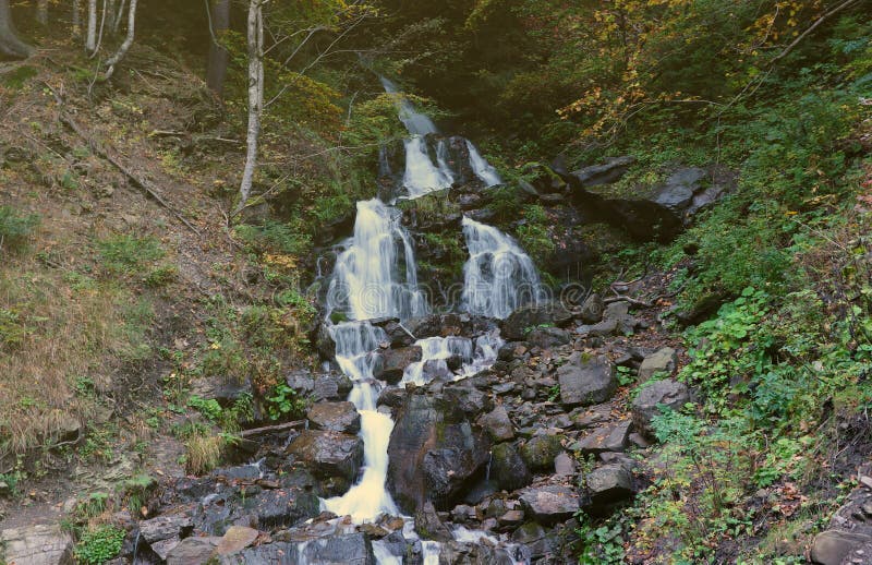 A Mountain Waterfall Flows Over the Rocks. Waterfall Cascade on Mossy ...