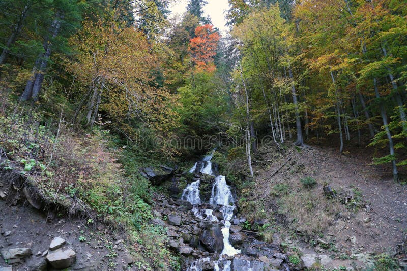 A Mountain Waterfall Flows Over the Rocks. Waterfall Cascade on Mossy ...