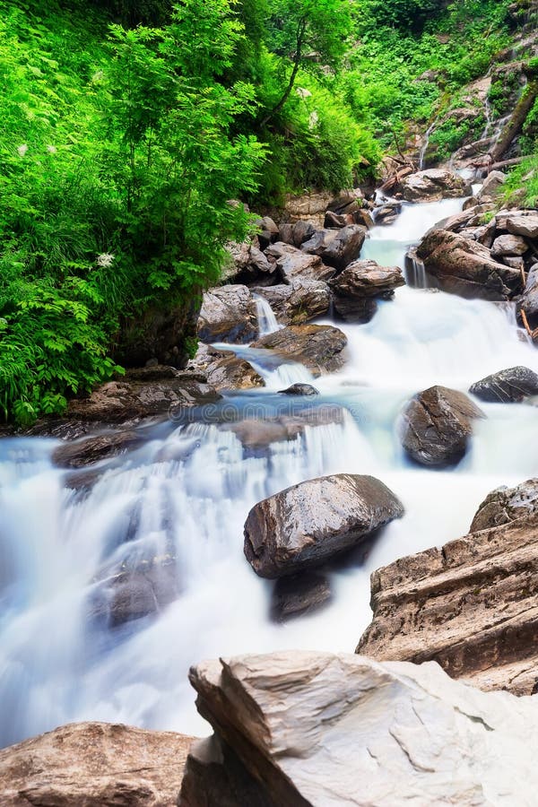 A Mountain Waterfall Flows Over the Rocks. Deep Rainforest Waterfall ...