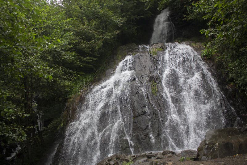 Mountain Waterfall Flows Over the Rocks. View of the Mountain Cascade ...