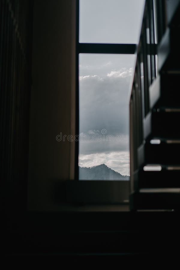 Mountains and Clouds Outside the Window Near the Stairs Stock Image ...