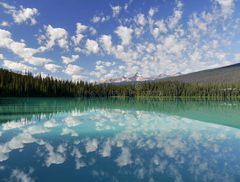 Mountains and Clouds Reflected in a Mountain Colored Lake. Stock Image ...