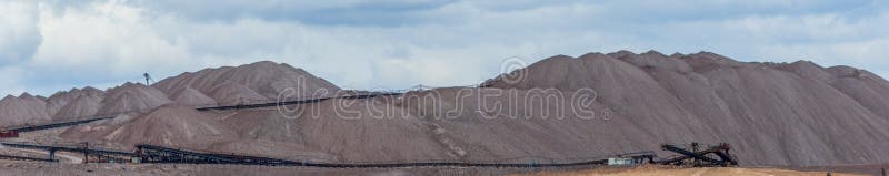Mountains of Empty Ore when Mining Potassium on Cloudy Sky Background. Transportation of an ...