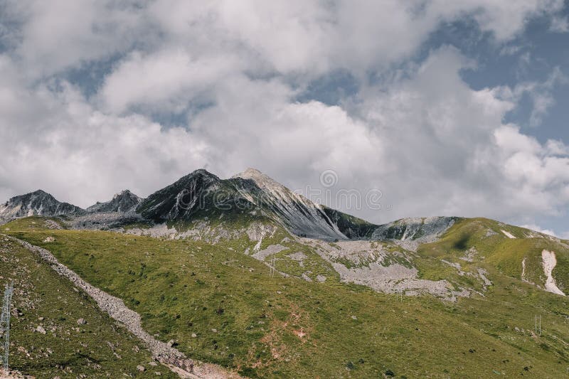 The Mountains with a Path Going through Them and Clouds Overhead Stock ...