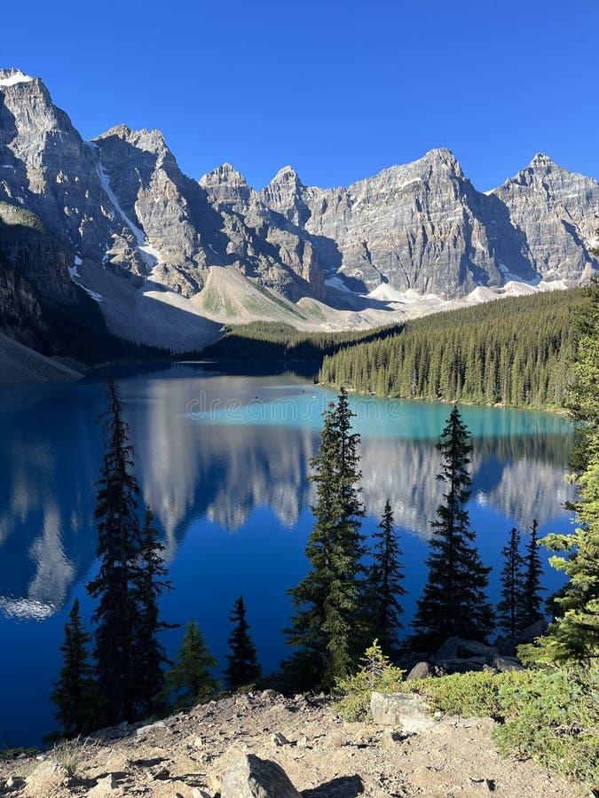 Mountains and Pine Trees Reflected in an Aquamarine Lake in Banff ...