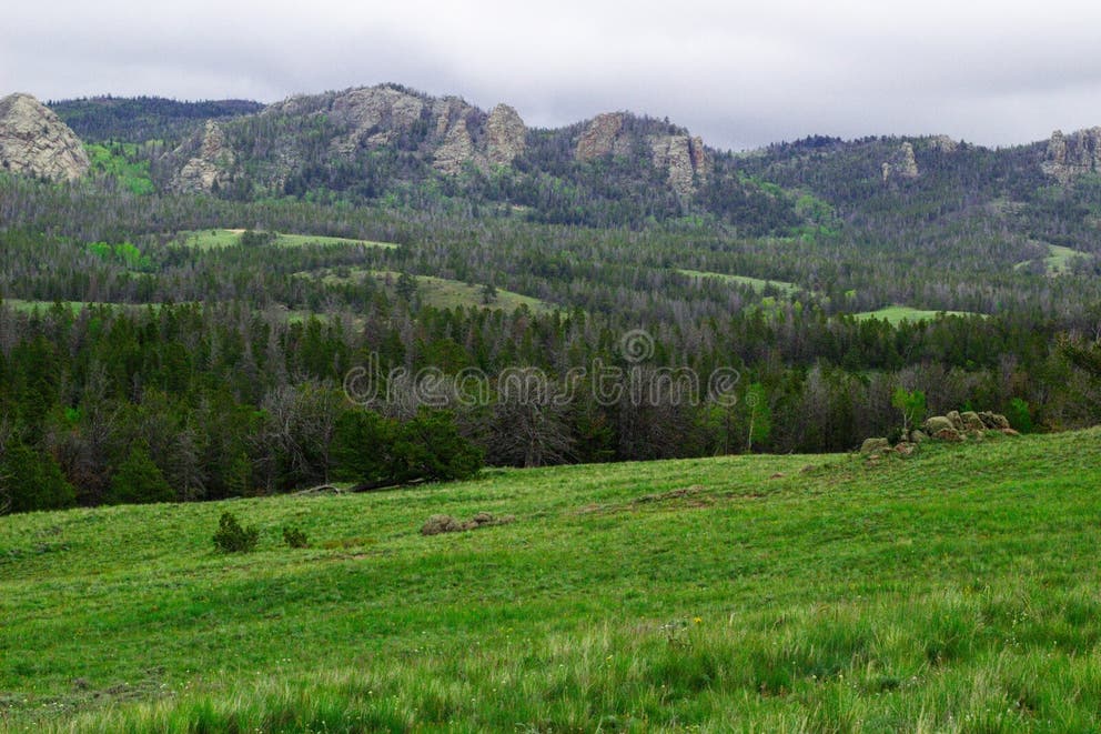 Mountains Set Back Behind Green Rolling Hill Stock Image - Image of ...