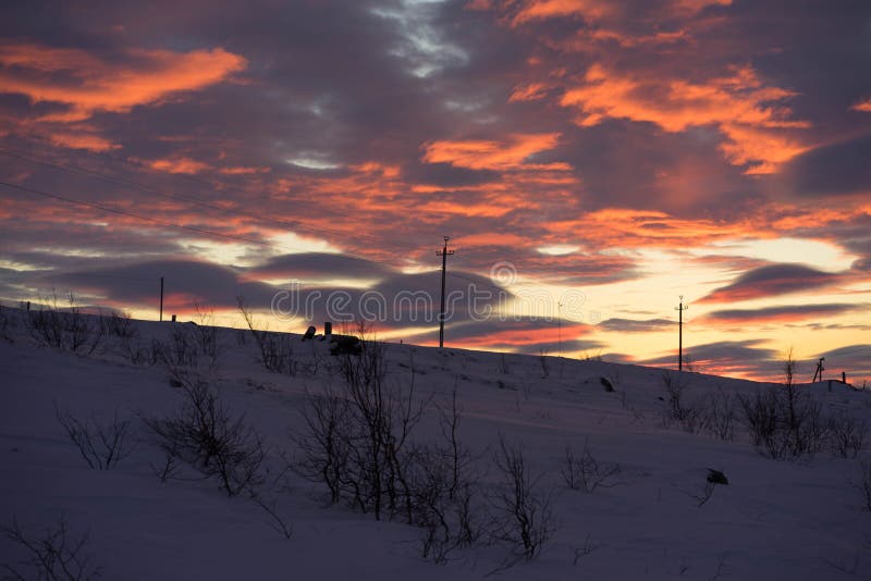 Mountains of Snow on the Background of the Rising Sun and Clouds Stock ...