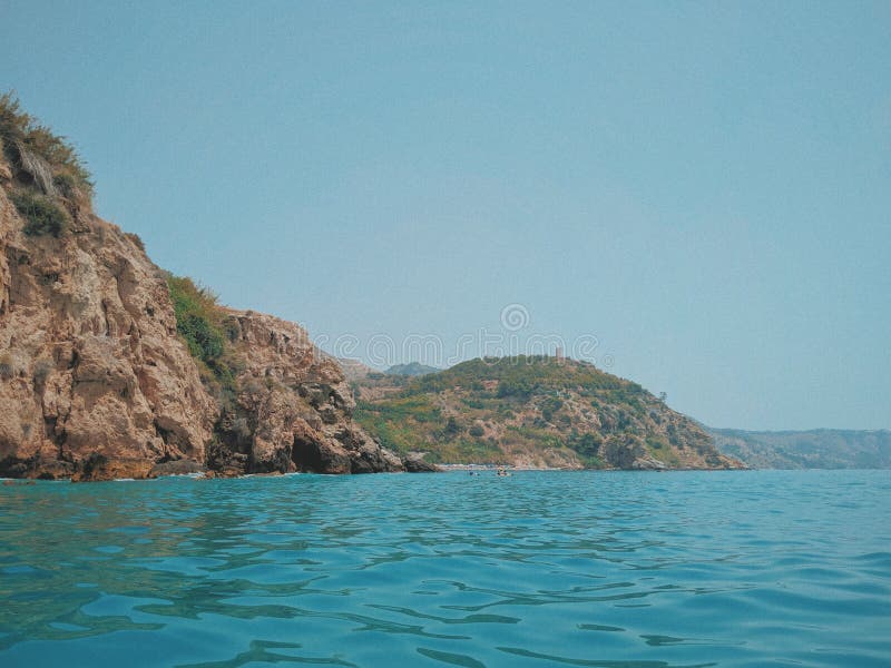 Mountains Sticking Out of the Water Under the Blue Sky Stock Image ...