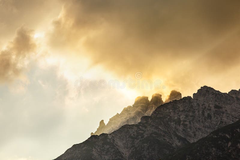 Mountains Stone Peaks with Orange Clouds Under Sunset Light. Stock ...