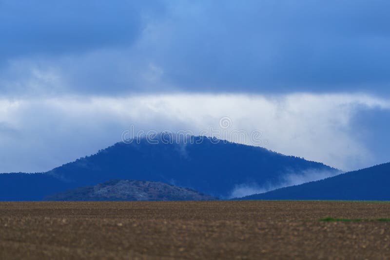 Mountains with Storm Clouds and Crop Fields Stock Photo - Image of ...