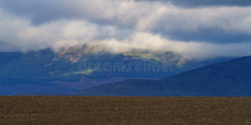 Mountains with Storm Clouds and Crop Fields Stock Image - Image of ...