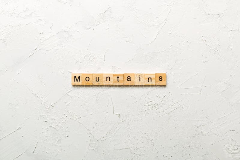 Mountains Word Written on Wood Block. Mountains Text on Cement Table ...