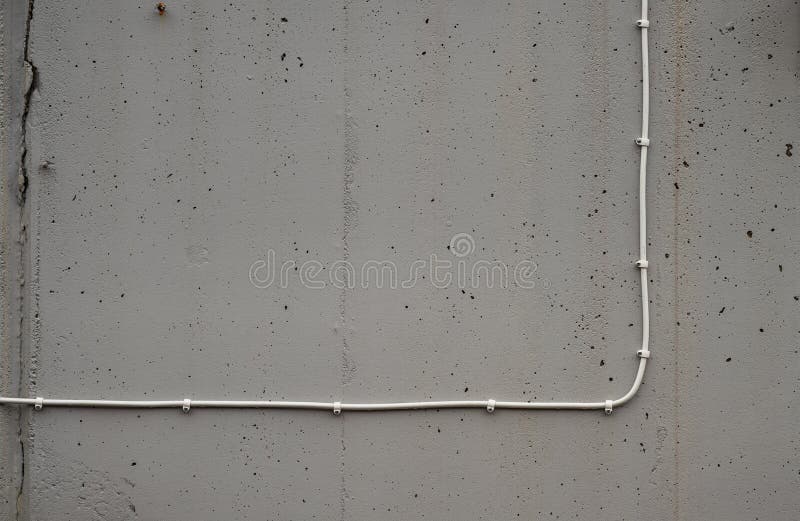 Mounted Cable Conduit on Textured Wall.. Stock Photo - Image of wire ...