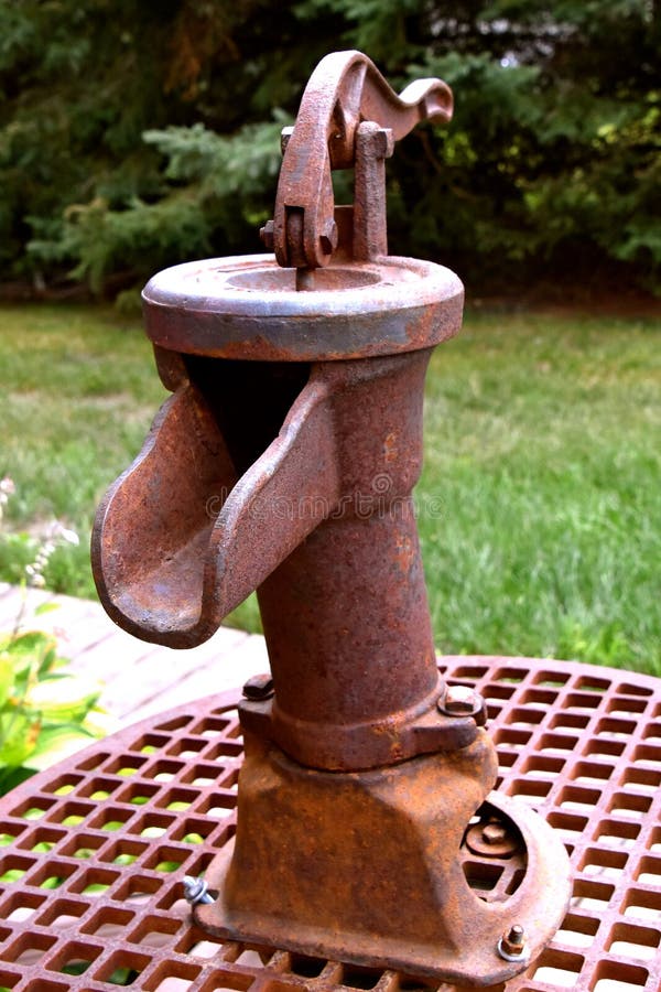 Old Rusty Hand Water Pump Attached To a Metal Grate Stock Photo - Image ...