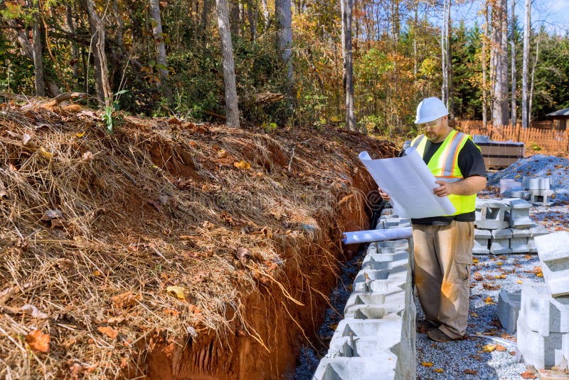 In Mounting Retaining Wall by Cement Blocks, Construction Workers Study ...