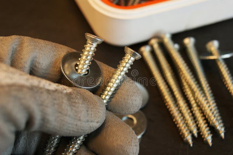 Mounting Screws in the Builder S Hand. Builder S Work Process. Stock ...