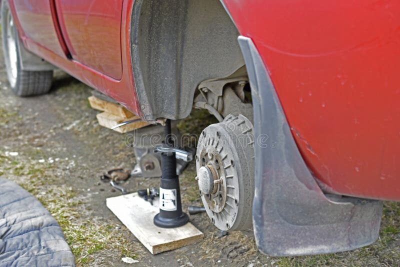 Mounting the Wheel at the Red Car Stock Photo - Image of stabilizer ...