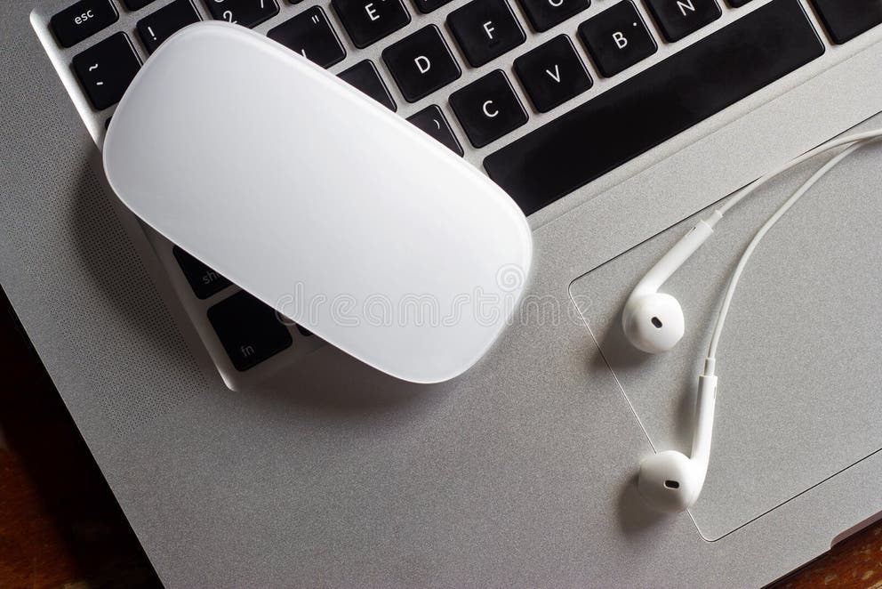 Mouse and Earphone on Laptop Computer Keyboard Stock Photo - Image of ...