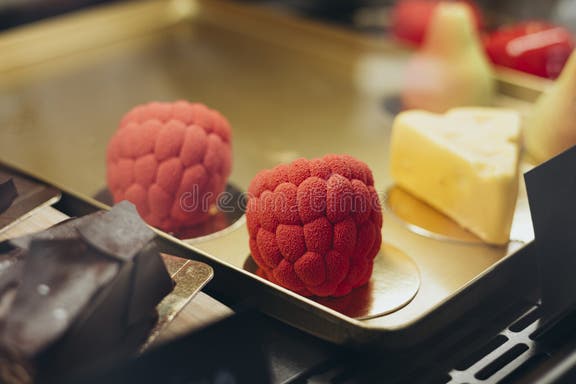 A Mousse Dessert in the Shape of a Raspberry Berry on a Display Window ...