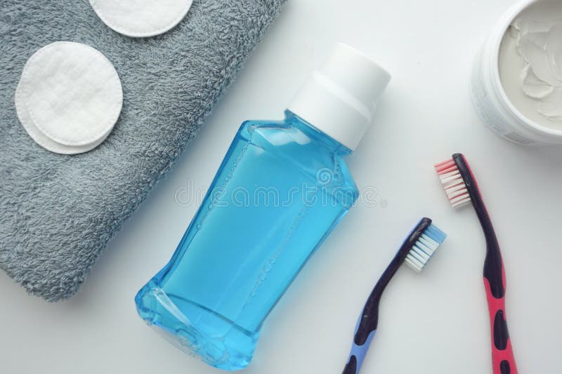Mouthwash Liquid in a Container and Toothbrush on White Background ...