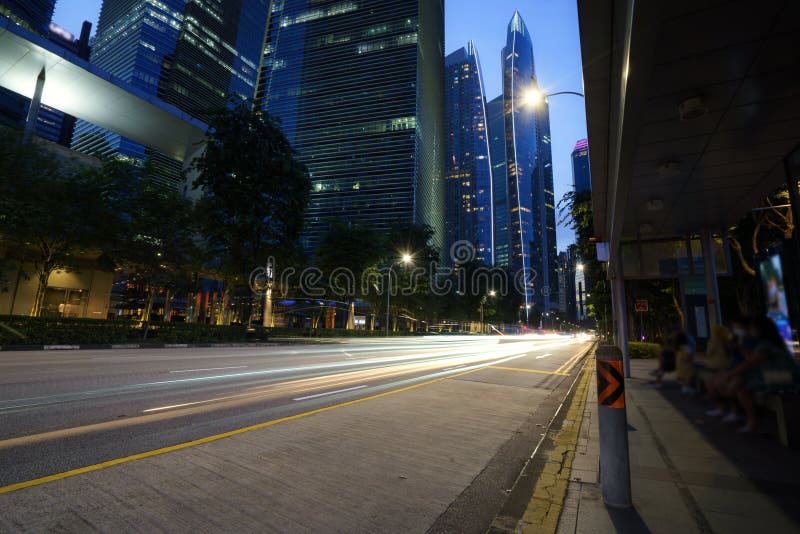 Movement of Car Lights Against Singapore Skyline during Sunset Stock ...