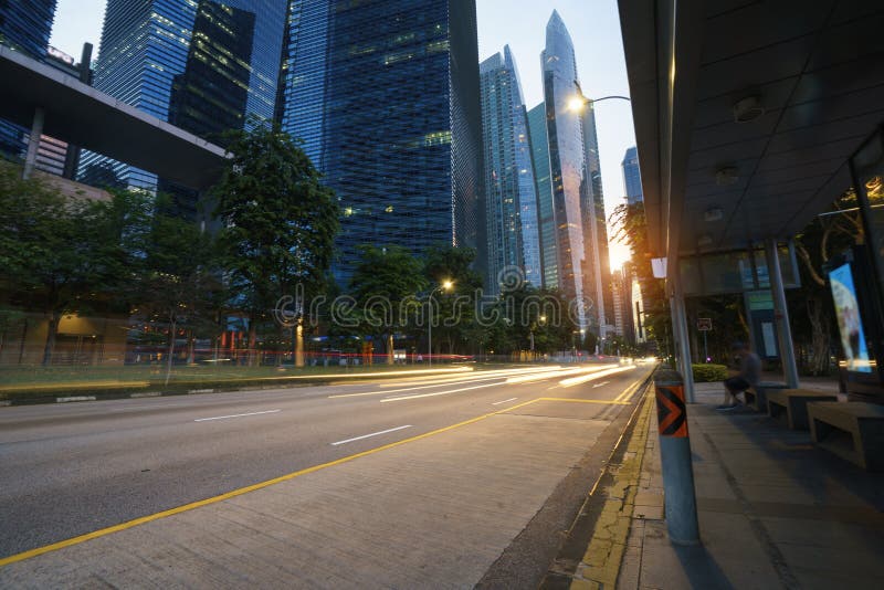 Movement of Car Lights Against Singapore Skyline during Sunset Stock ...