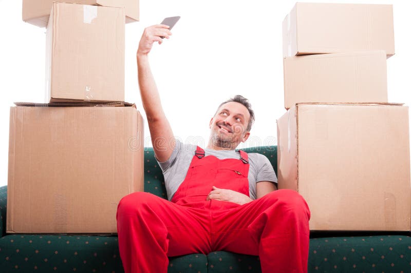 Mover Man Sitting on Couch Talking a Selfie with Smartphone Stock Photo ...
