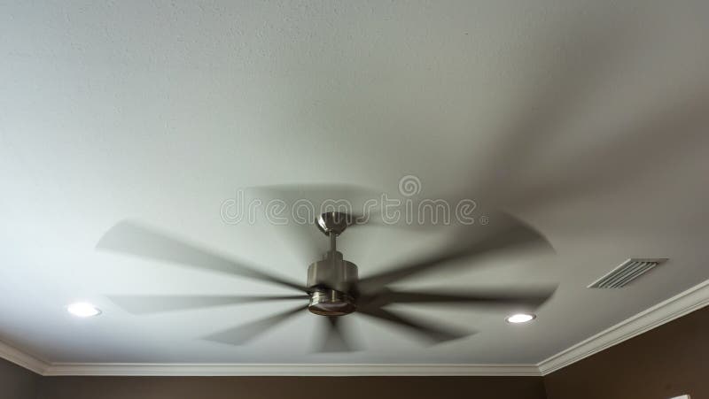 A Moving and Blurred Interior Fan Inside a New Construction House with ...